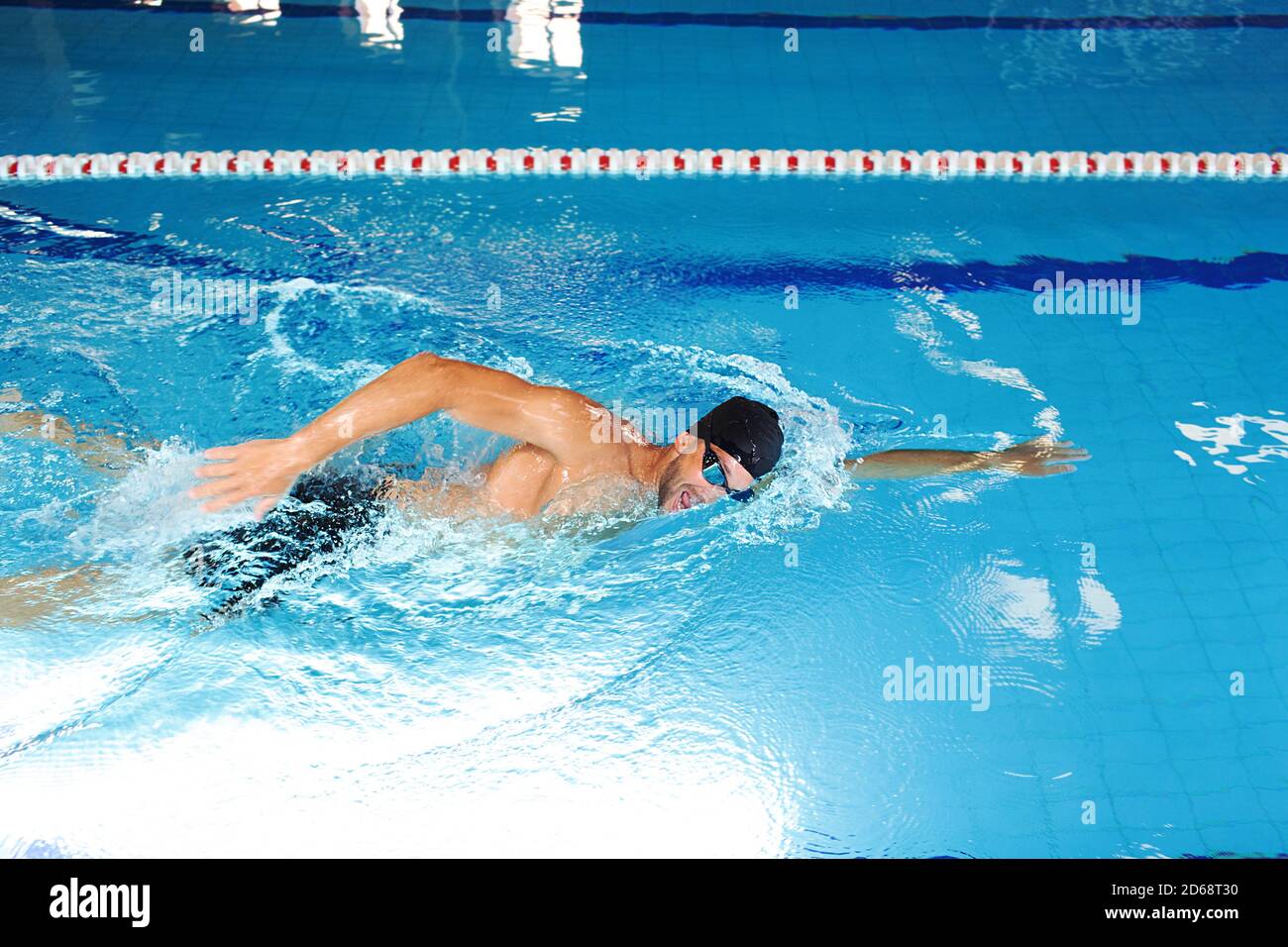 Man swimmer is swimming in the pool. Freestyle stroke, front crawl stroke. swimming in blue pool ...