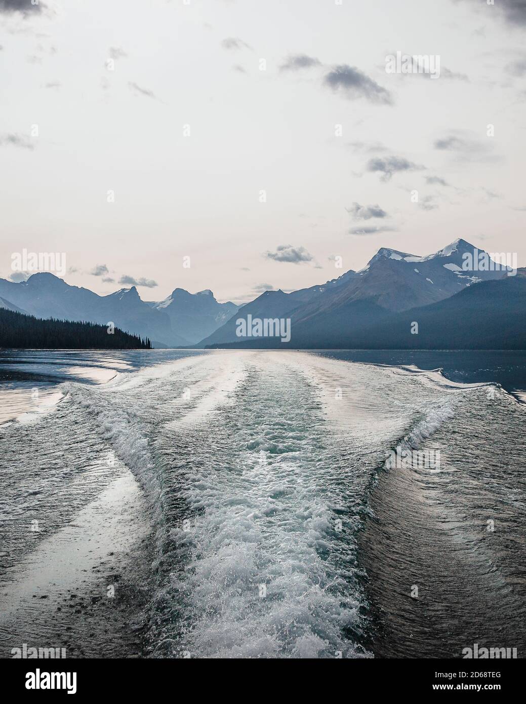 Mesmerizing view of a lake with beautiful snow-capped mountains in ...