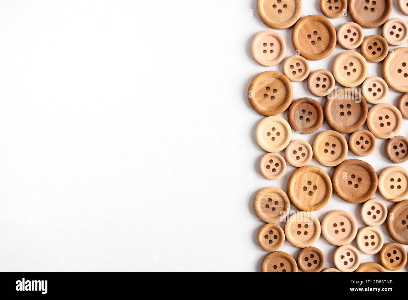 various wooden beige buttons on a white background, top view flat lay ...