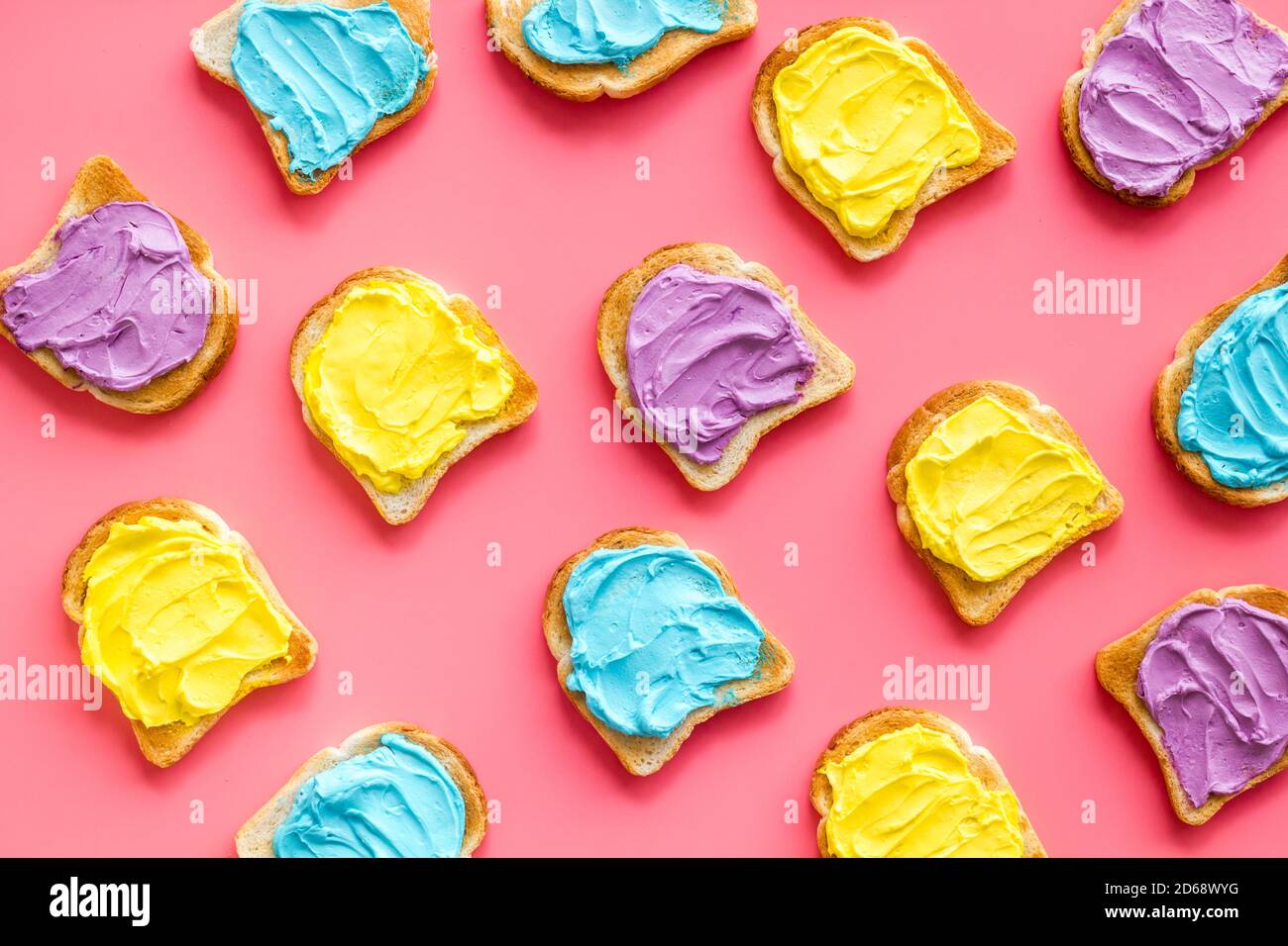 Funny toasted bread with colored cheese spread. Overhead view Stock ...