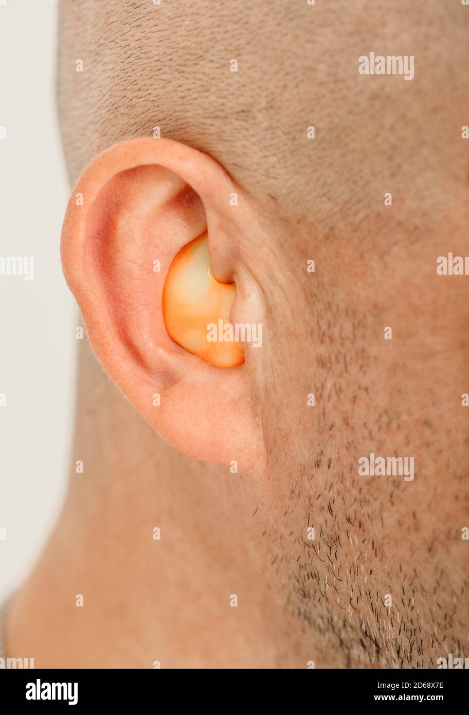 Customized orange ear plugs for noisy places. Personally molded ...