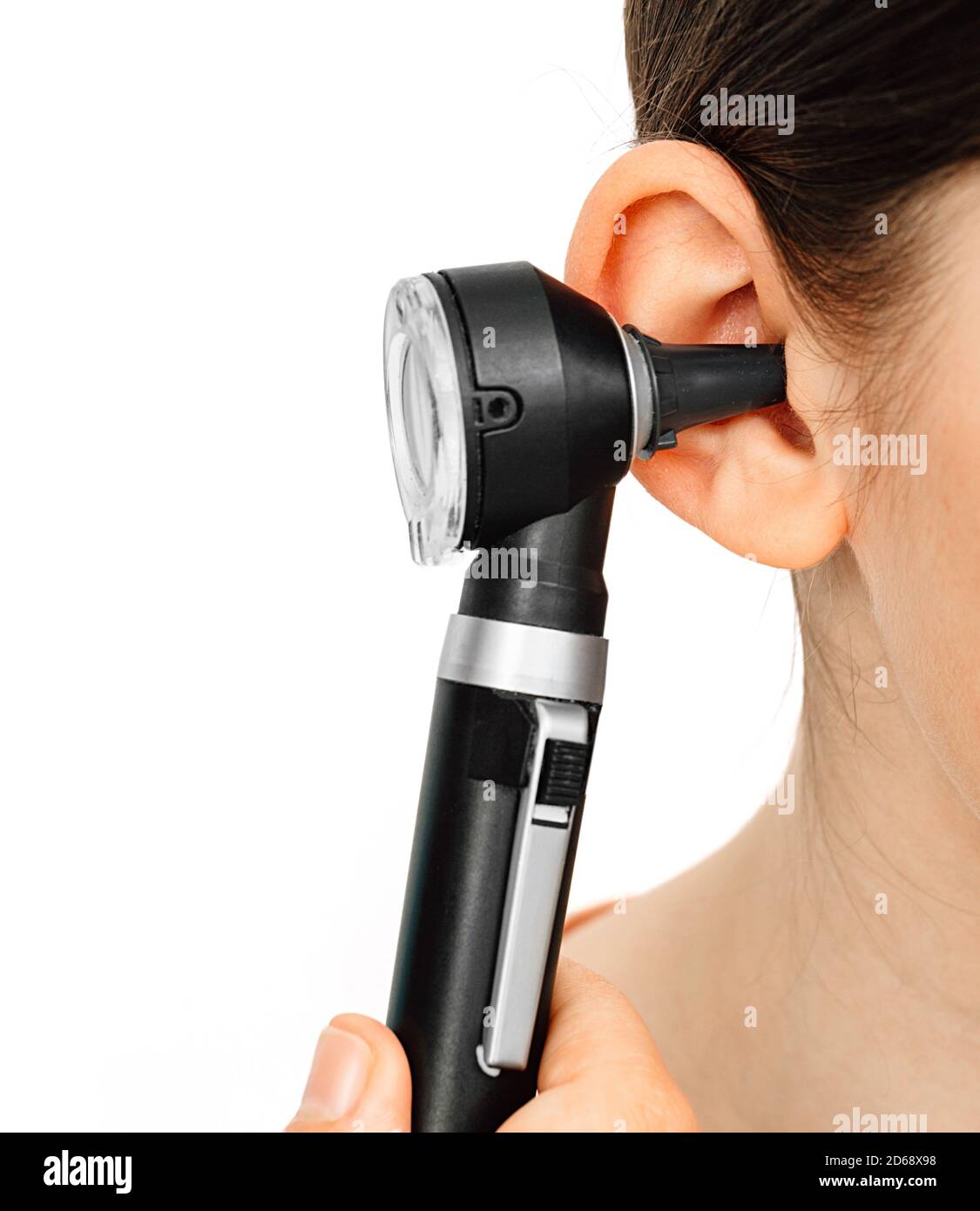 Hearing exam. Otoscope and ear of a child close-up isolated on white ...