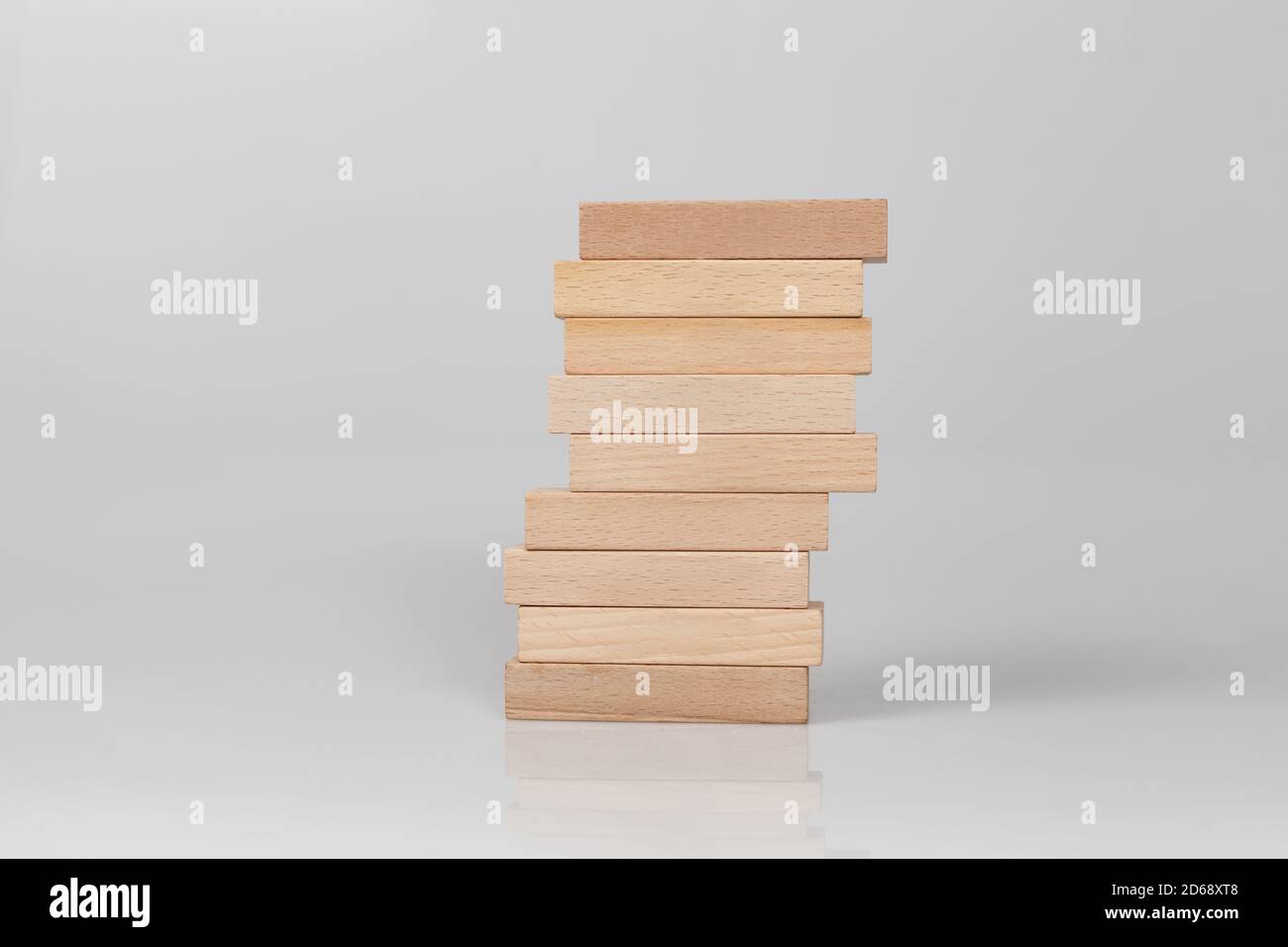 Wooden block tower made from small wooden blocks isolated on a gray ...