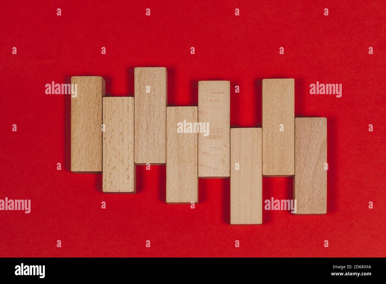 Arrangement of wood block stacking as a step stair isolated on a red ...