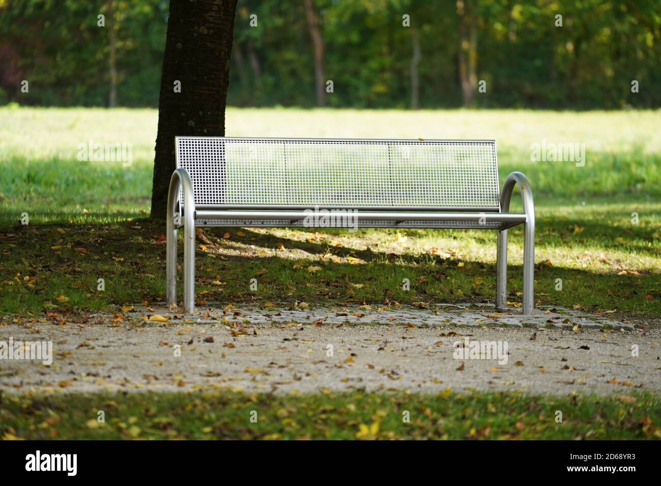 Selective focus shot of an iron bench in a park Stock Photo - Alamy