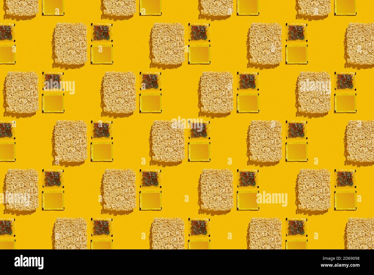 Pattern instant noodle with seasoning bags the top view on a yellow ...