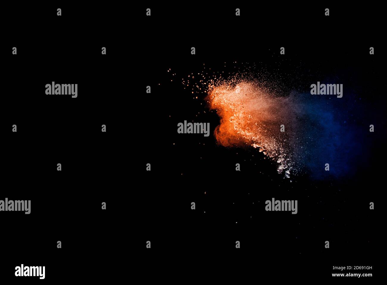 Orange blue color powder explosion on black background Stock Photo - Alamy
