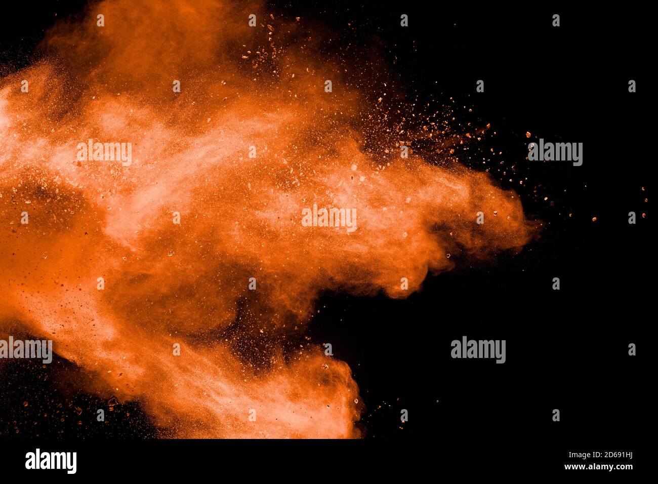 Orange powder explosion on black background Stock Photo - Alamy