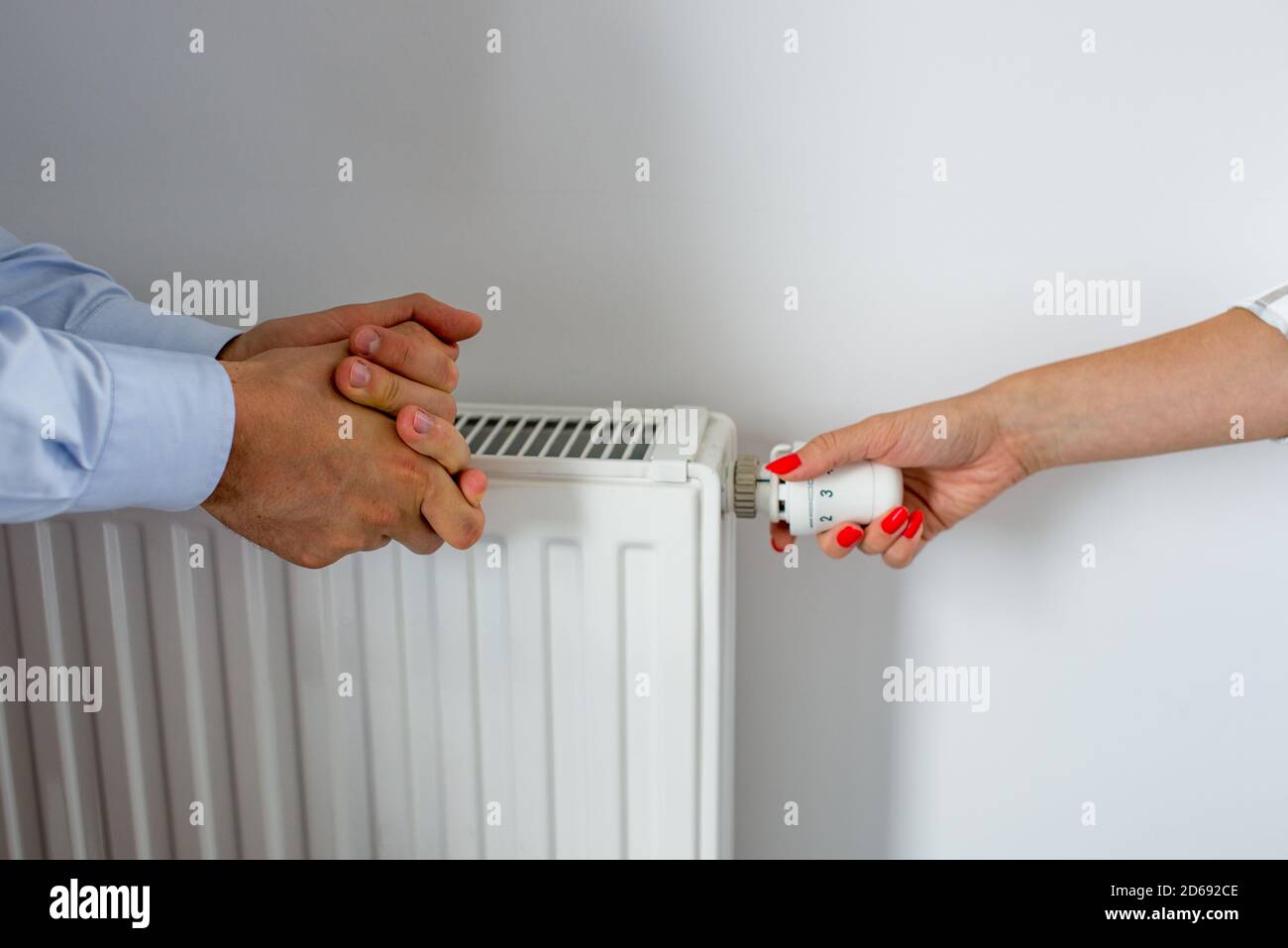 Woman Hand Adjusting The Knob Of Heating Radiator. A hand that ...