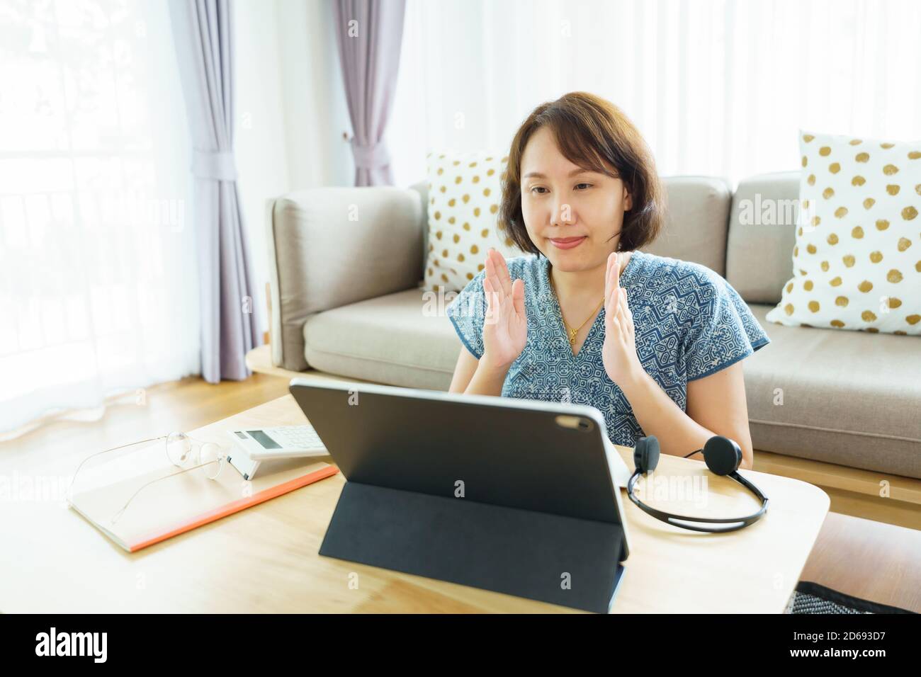 Asian woman aged 30-35 years using tablet, watching lesson Sign ...