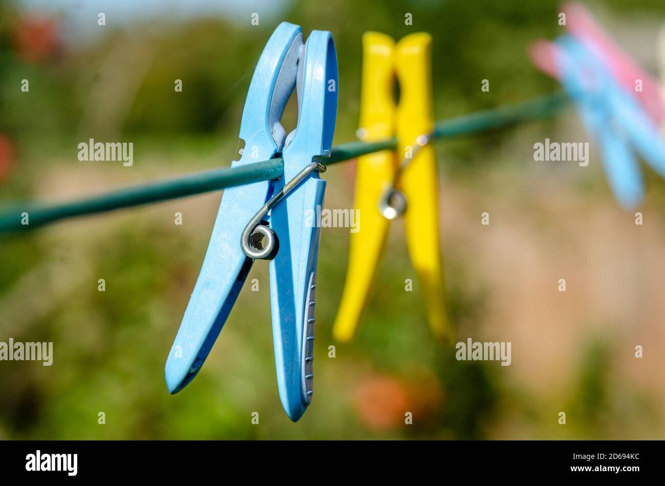 Plastic cloths pegs attached to a washing line in a garden Stock Photo ...