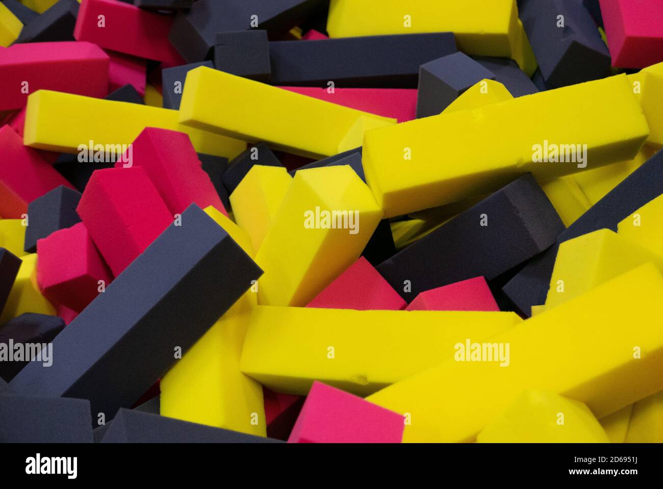Pool in the kid game center filled by yellow red and black cubes Stock ...