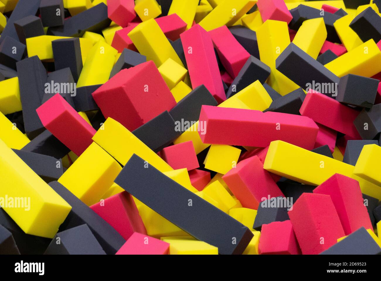 Pool in the kid game center filled by yellow red and black cubes Stock ...