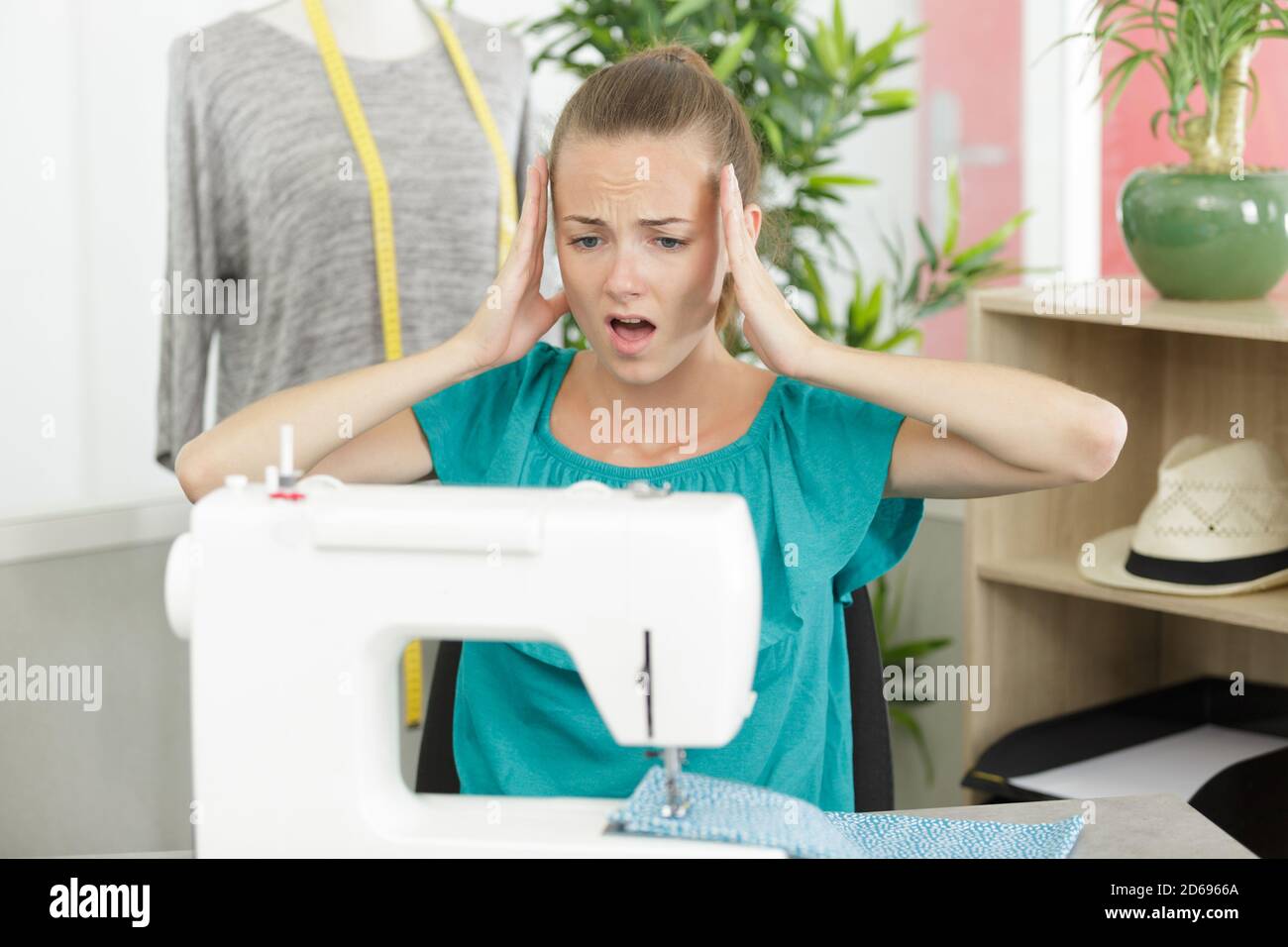 young seamstress woman having difficulties with sewing-machine Stock ...