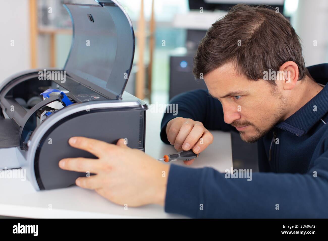 handyman fixing the office printer Stock Photo - Alamy