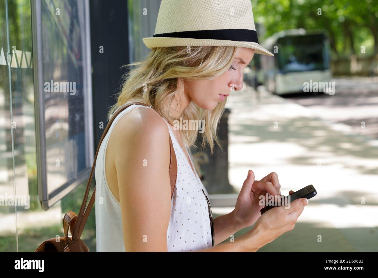 beautiful lady waiting at bus stop Stock Photo - Alamy