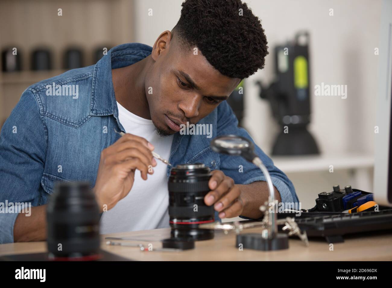yung man studying how to repair the camera Stock Photo - Alamy
