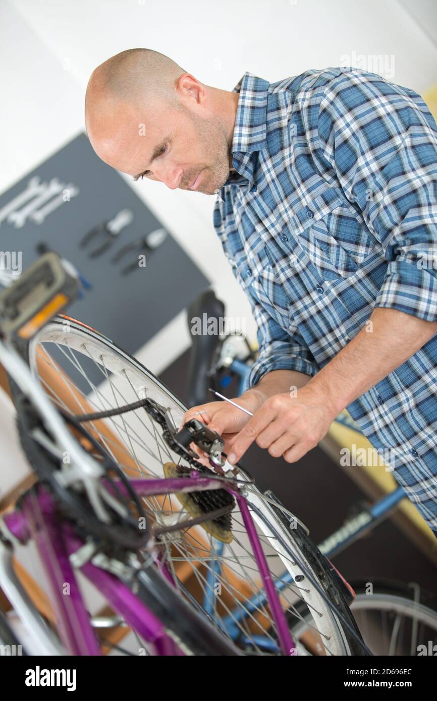 a man fixing a bike Stock Photo - Alamy