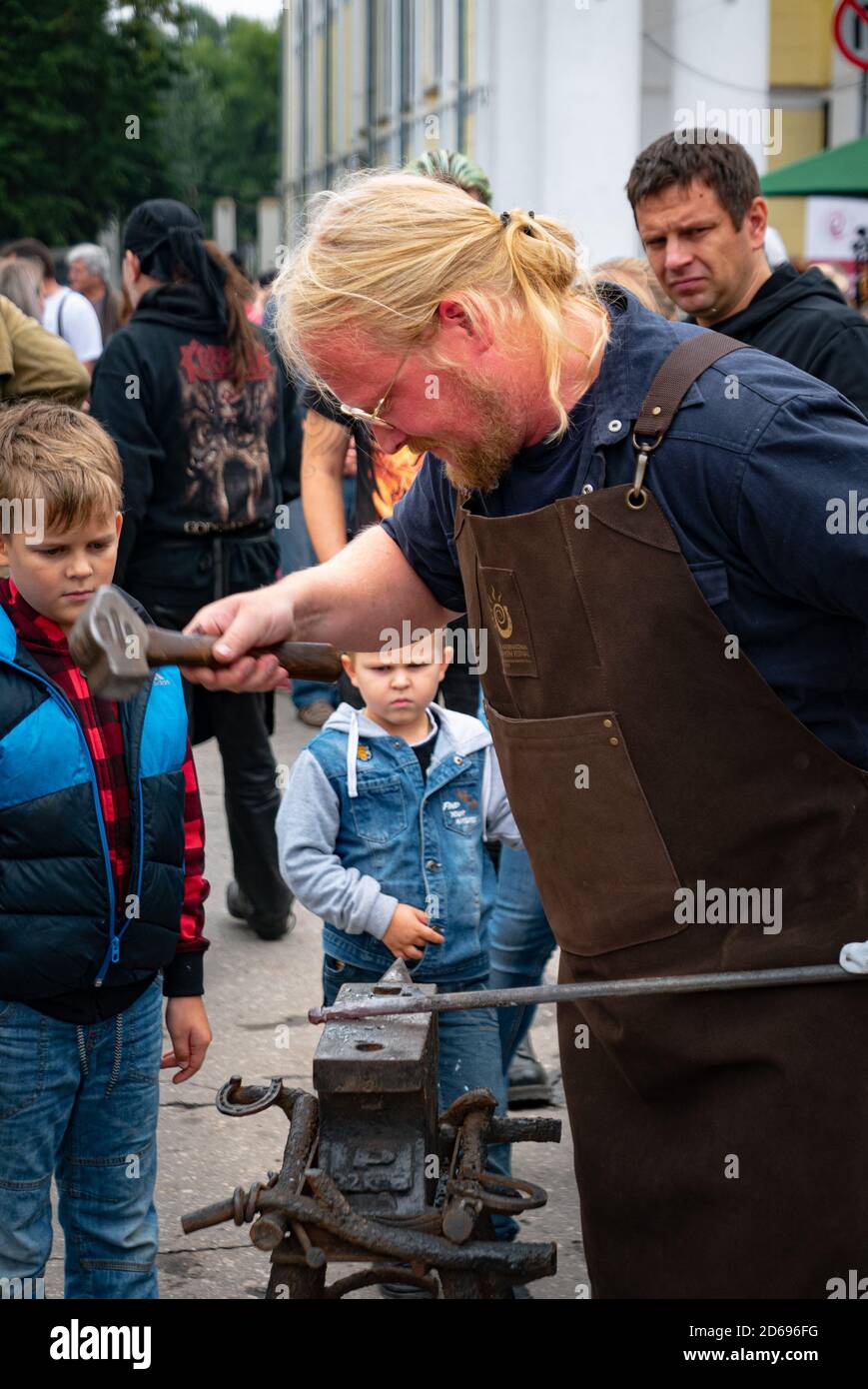 Ryazan, Russia - July 27, 2019: Brutal blacksmith hitting the metal ...
