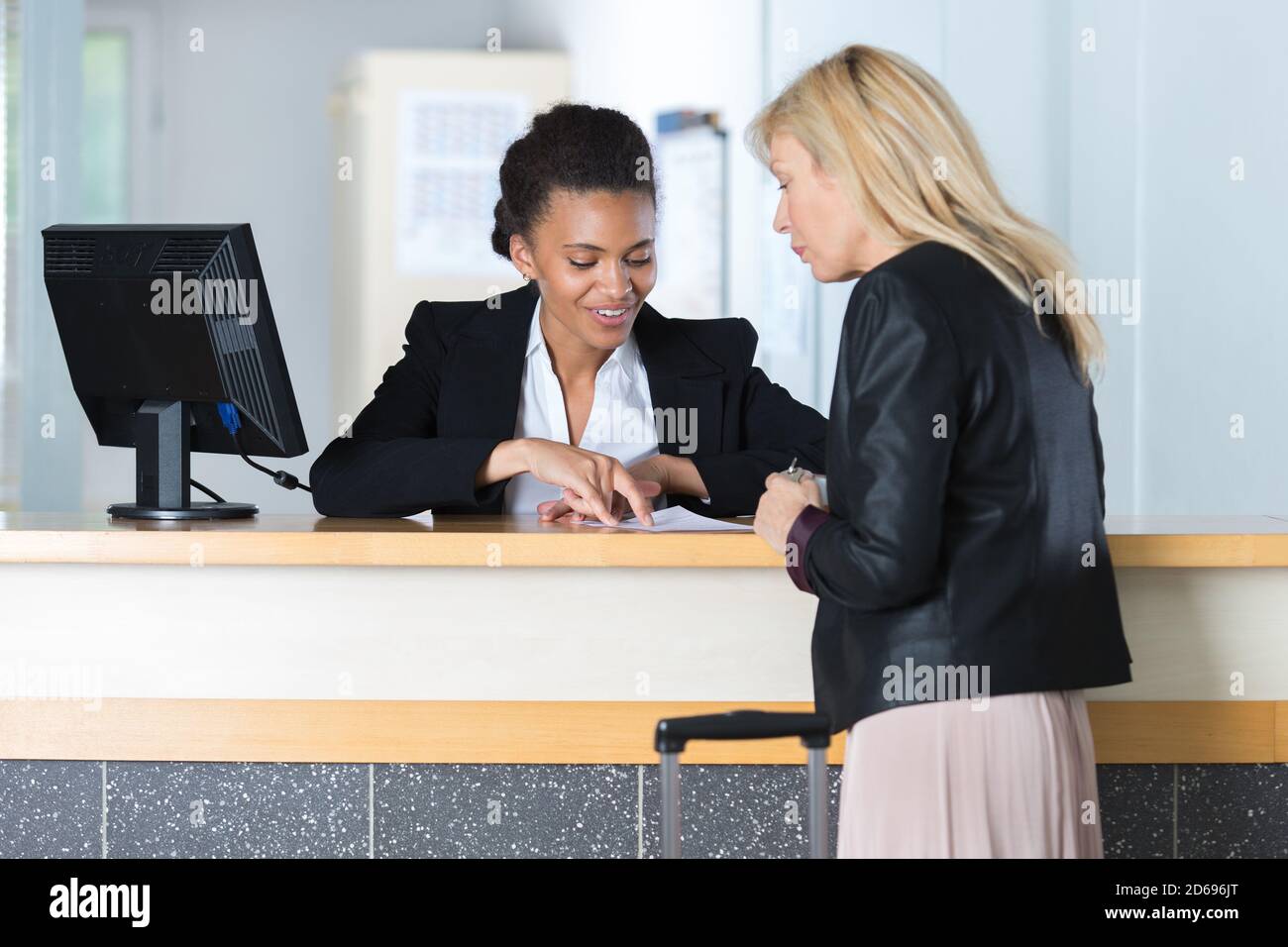 female guest in a hotel is checking in Stock Photo - Alamy