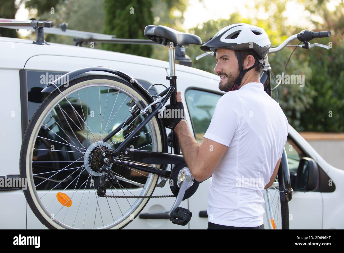 biker man take of his bike from the car roof Stock Photo - Alamy
