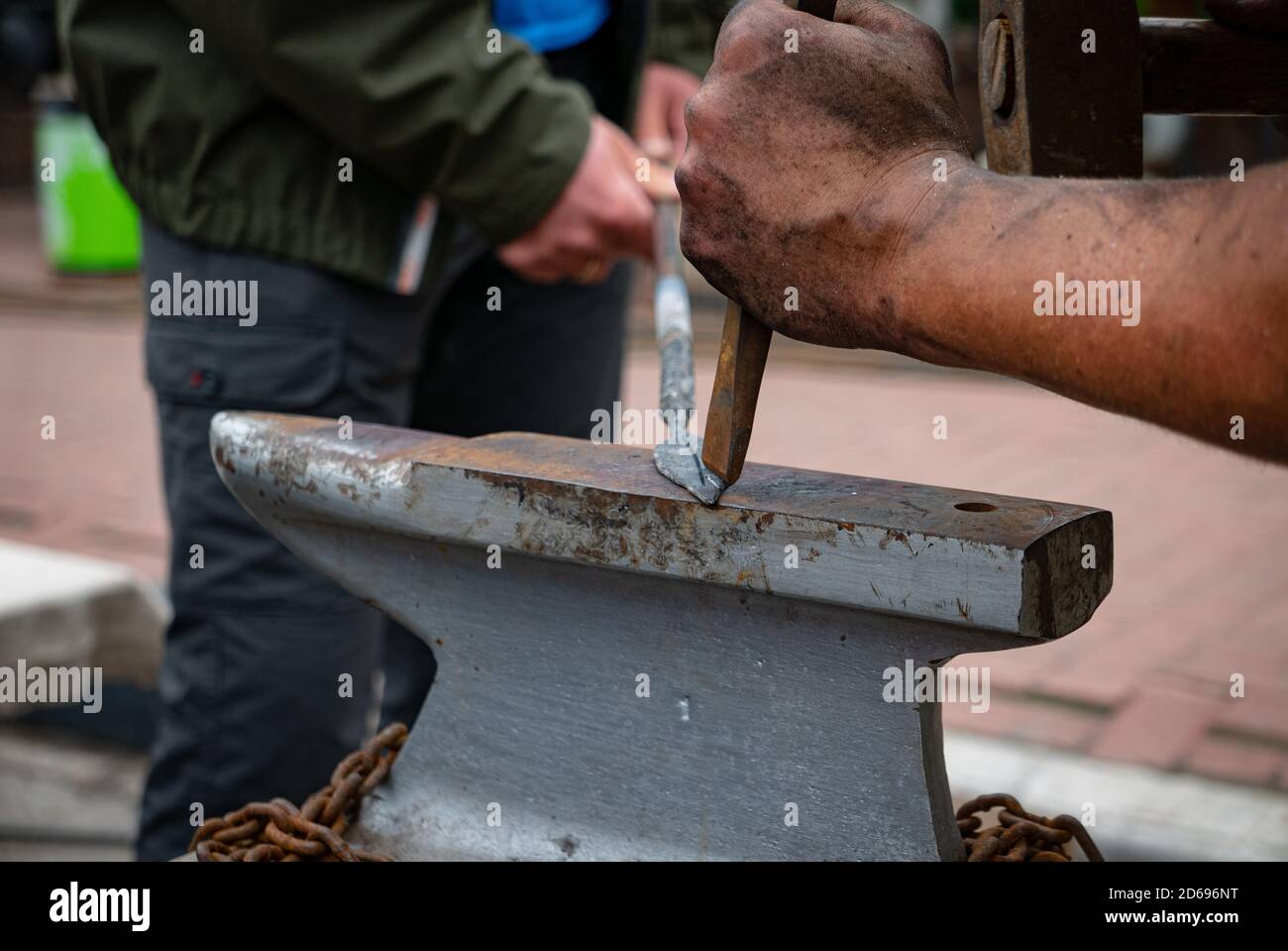 Blacksmith works with metal on an anvil Stock Photo - Alamy