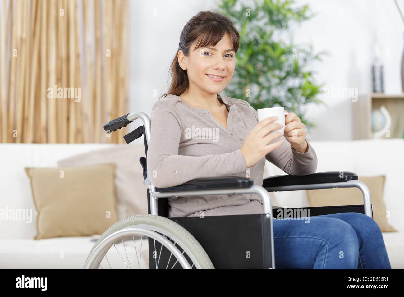 disable person in wheelchair having a coffee at home Stock Photo - Alamy
