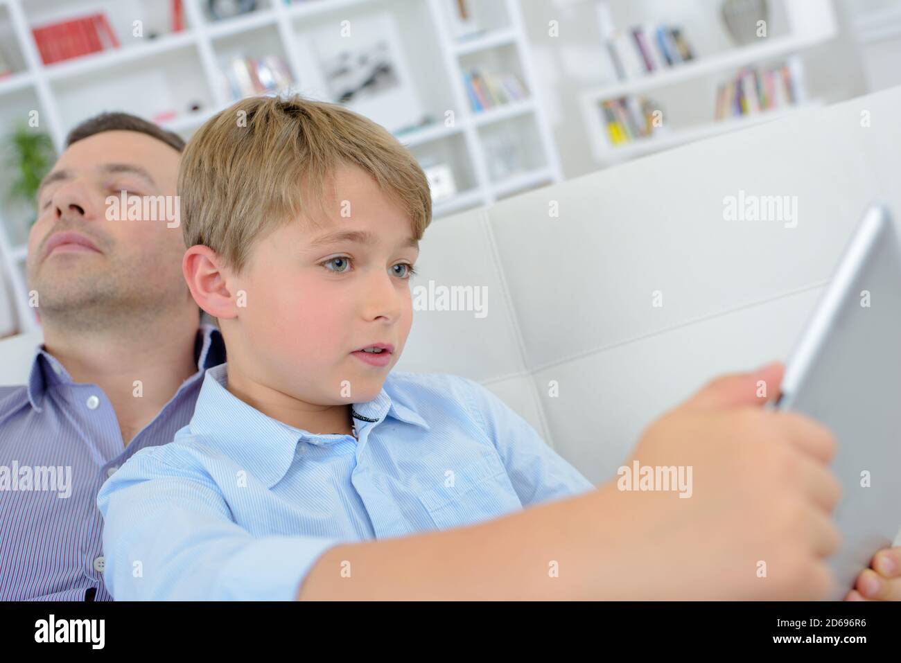 young boy using a tablet Stock Photo - Alamy