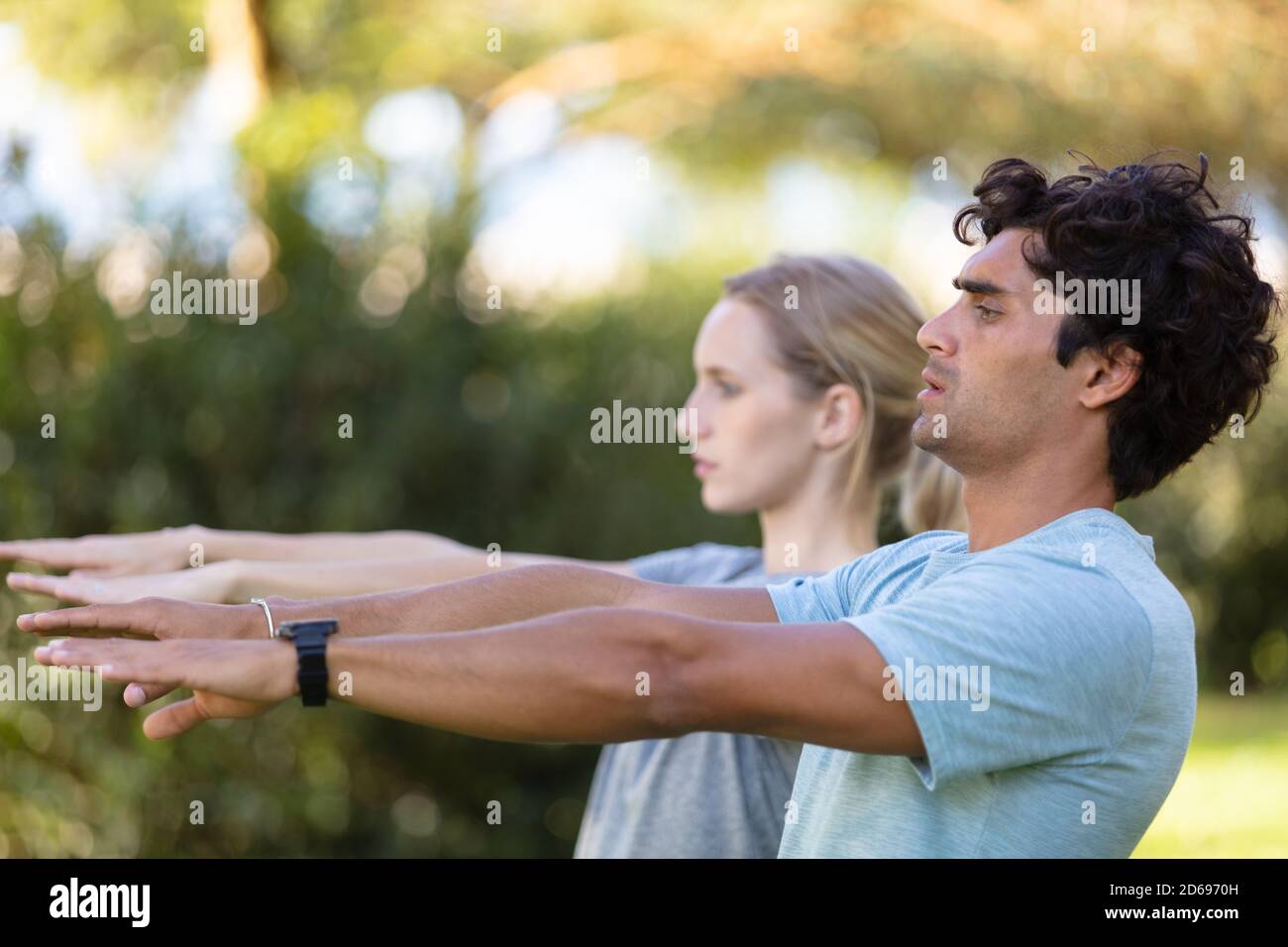 focused couple exercise with arms outstretched to the front Stock Photo ...