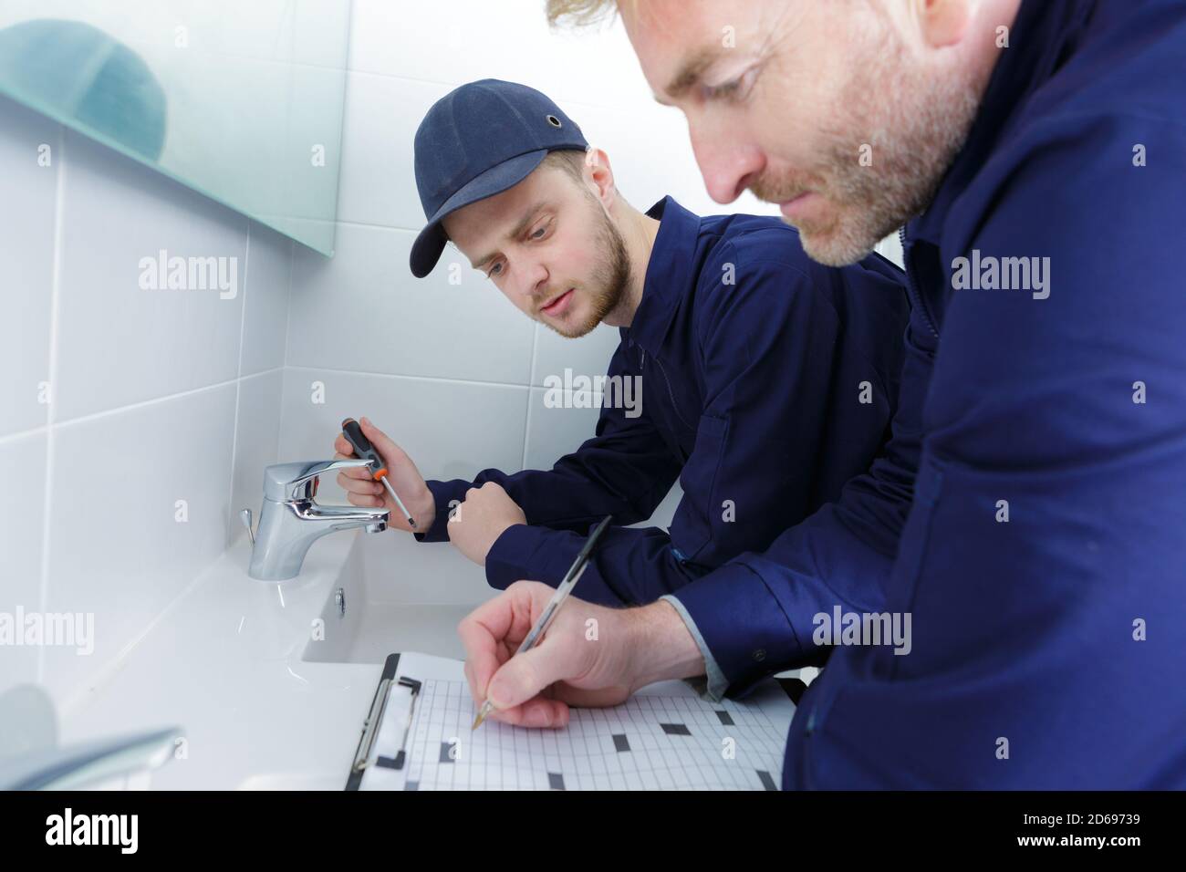 Two plumbers work hi-res stock photography and images - Alamy