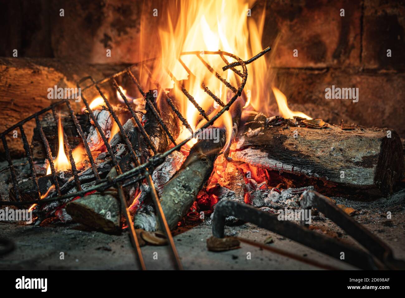 Burning wood to prepare the grill for barbecue Stock Photo - Alamy