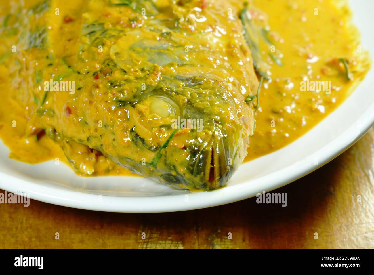 steamed mango fish dressing spicy curry sauce on plate Stock Photo - Alamy