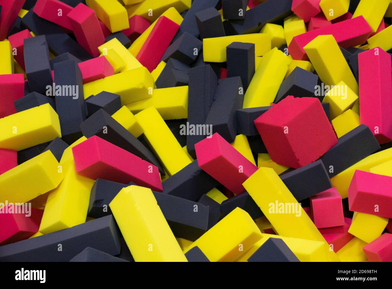 Pool in the kid game center filled by yellow red and black cubes Stock ...