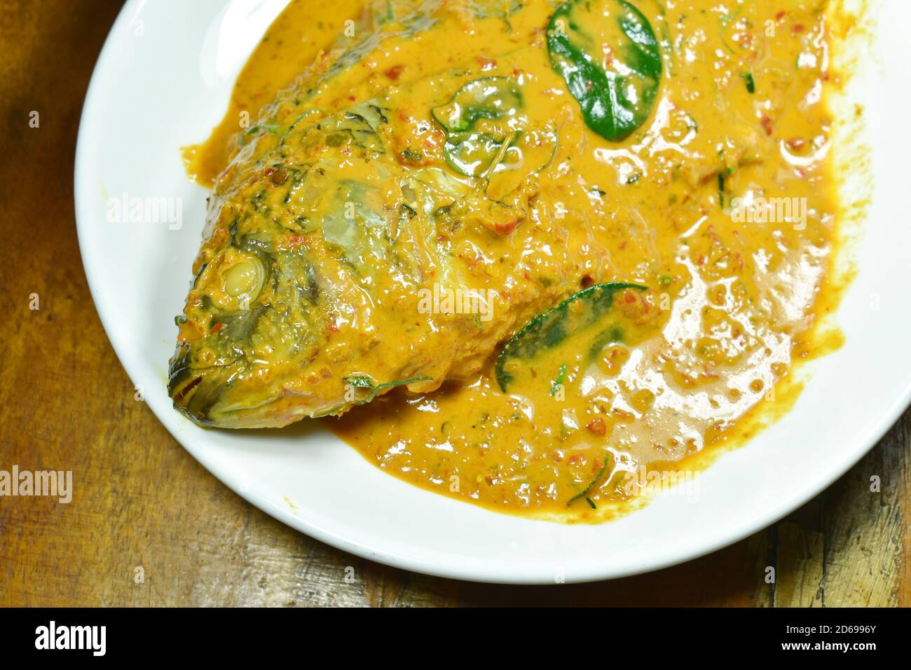 steamed mango fish dressing spicy curry sauce on plate Stock Photo - Alamy