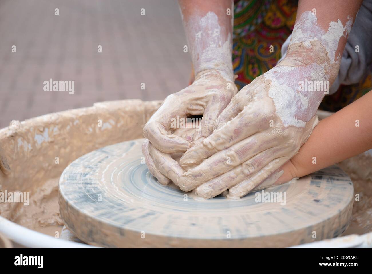 Hands forming clay on the pottery wheel Stock Photo - Alamy
