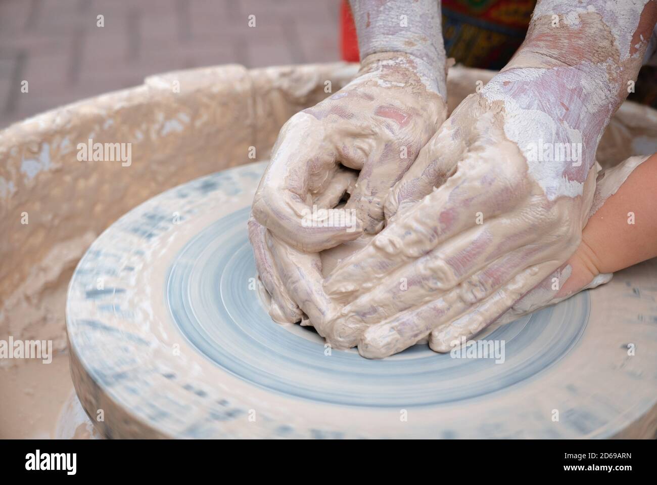 Hands forming clay on the pottery wheel Stock Photo - Alamy