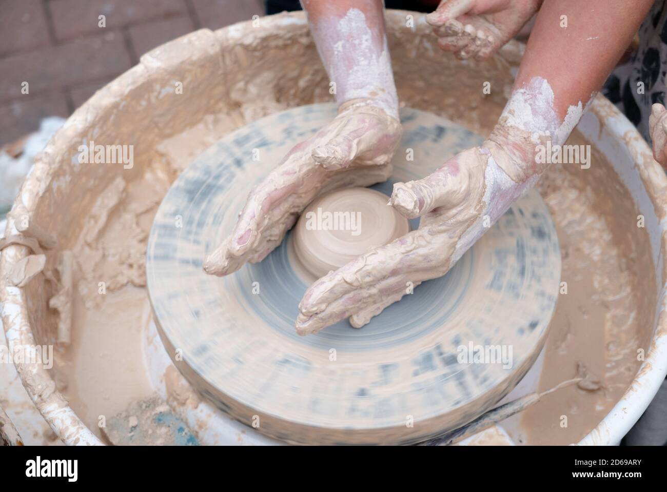 Potter forming clay on the pottery wheel Stock Photo - Alamy