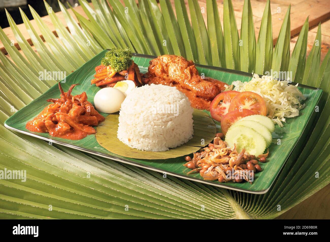 Indian mixed rice with chicken curry, squid curry, boiled egg, achaar ...