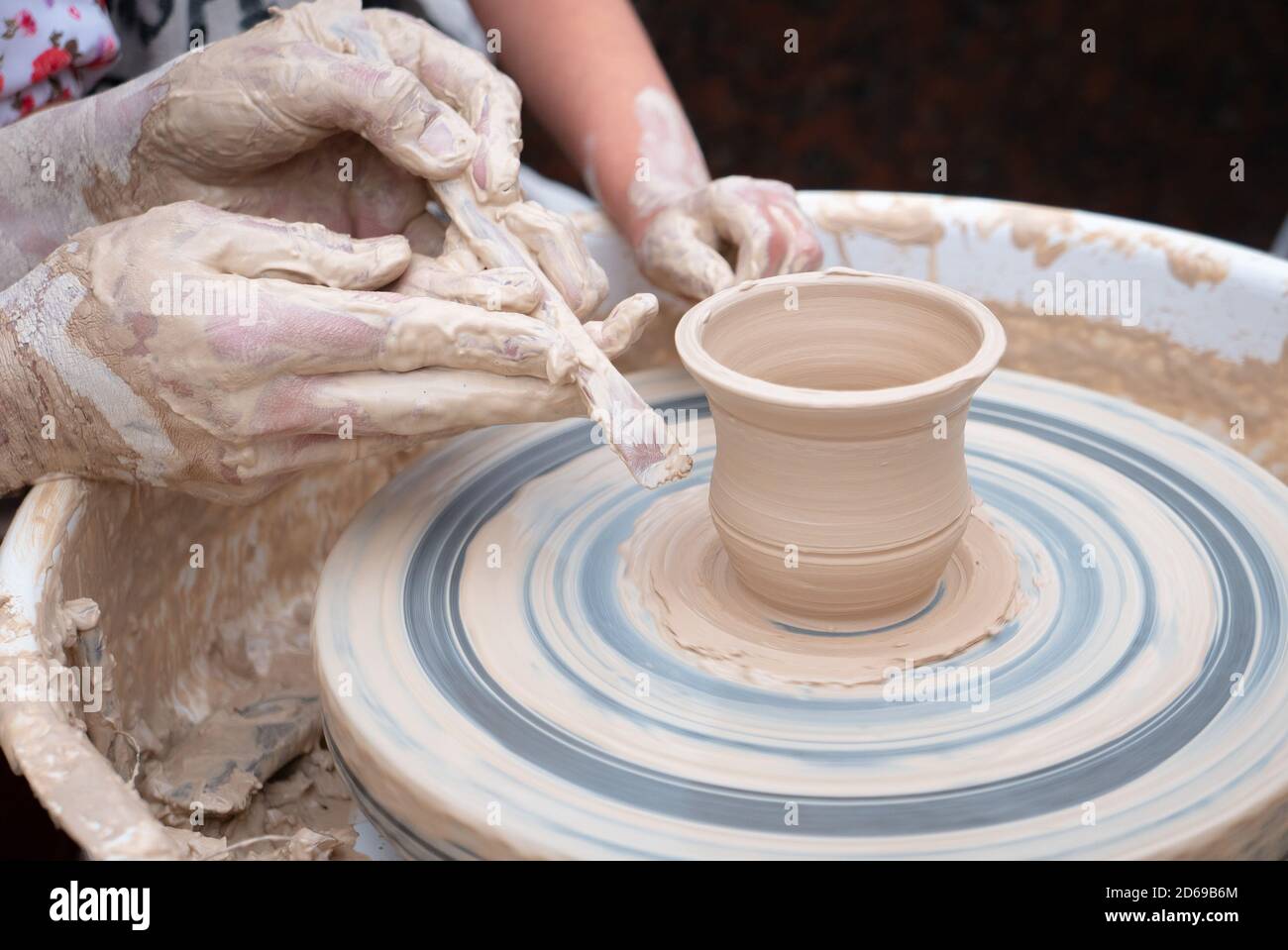 Potter forming a ceramic jug on pottery wheel Stock Photo - Alamy