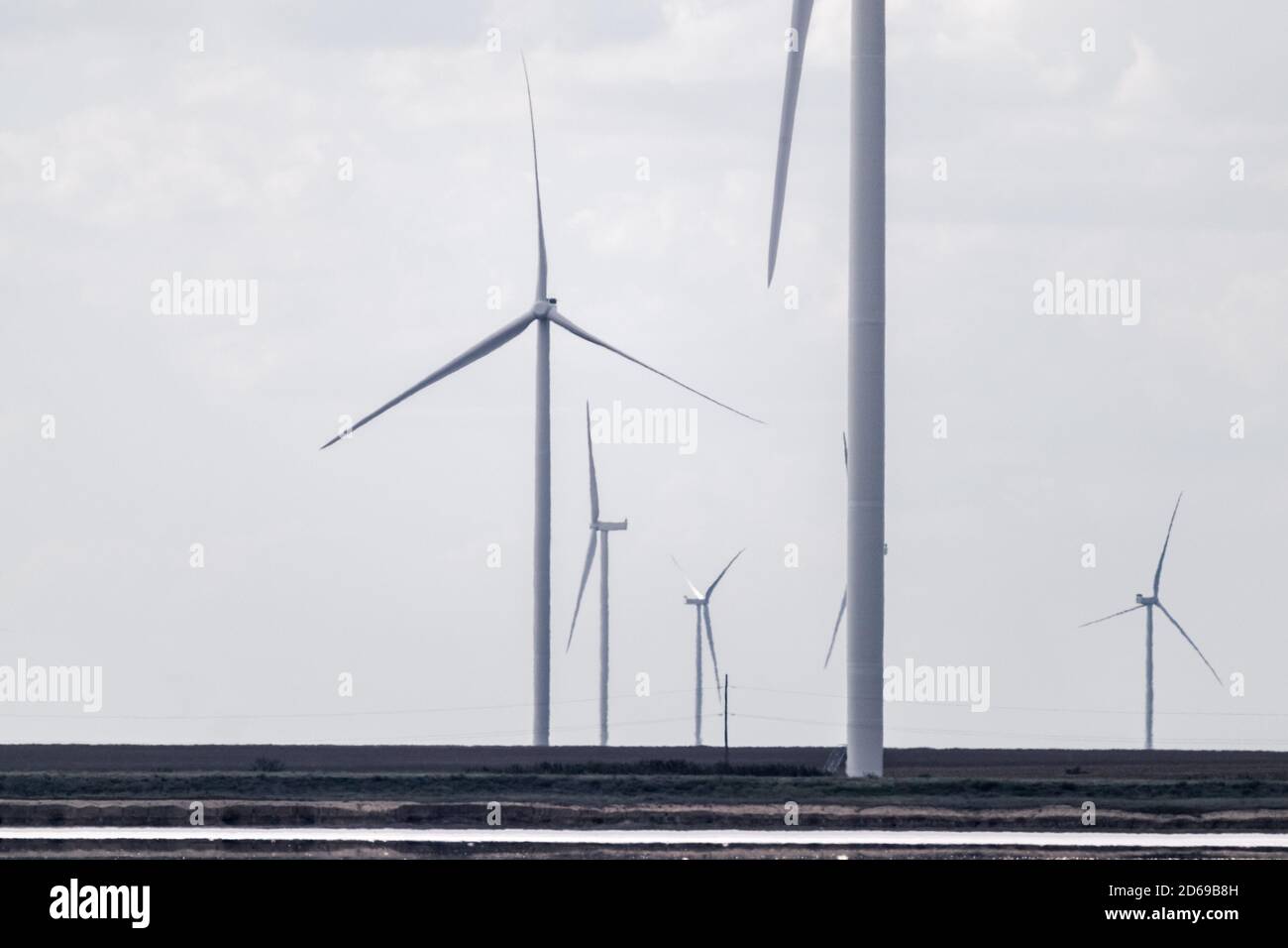 Wind generators farm on coast in grey colorless colors. Cloudy sky ...