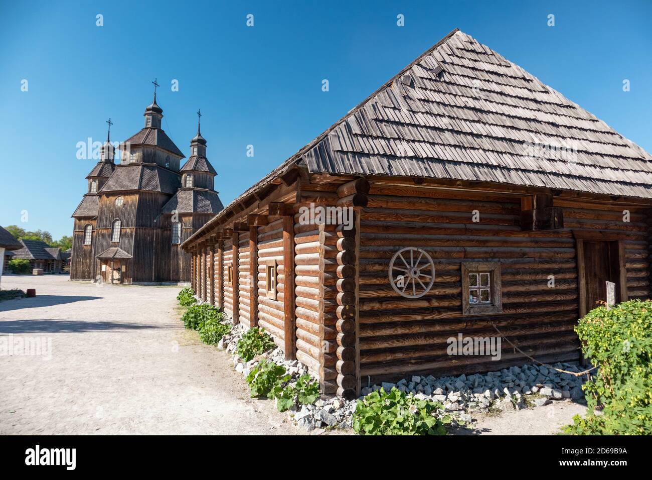 Wooden house and vintage church in Zaporozhian Sich medieval village ...