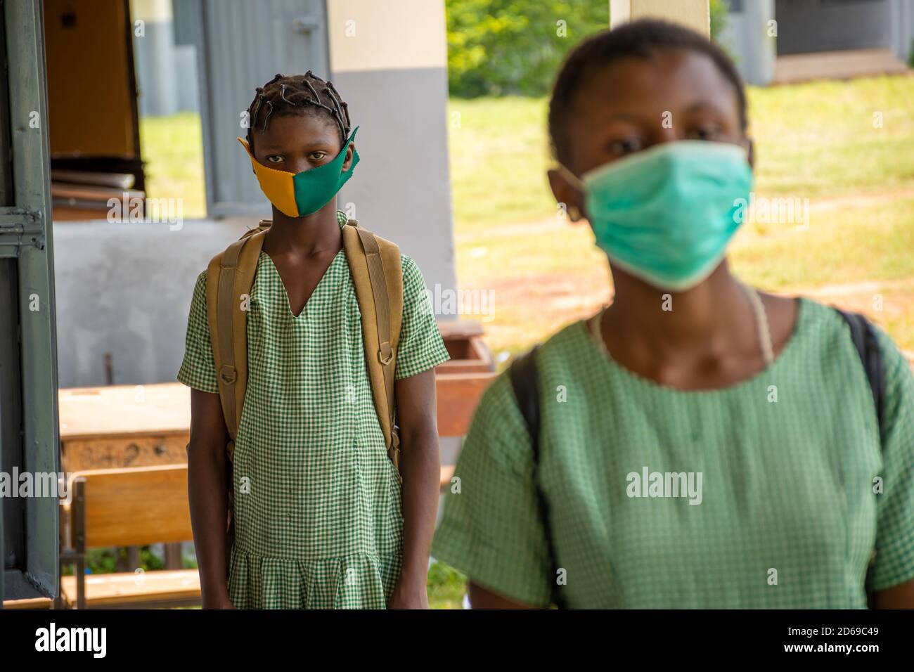 african school kids wearing face masks and observing physical ...