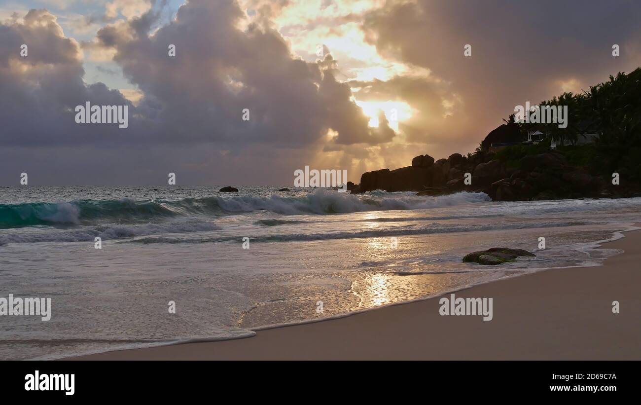 Beautiful sunset on tropical beach Anse Intendance on the west coast of ...