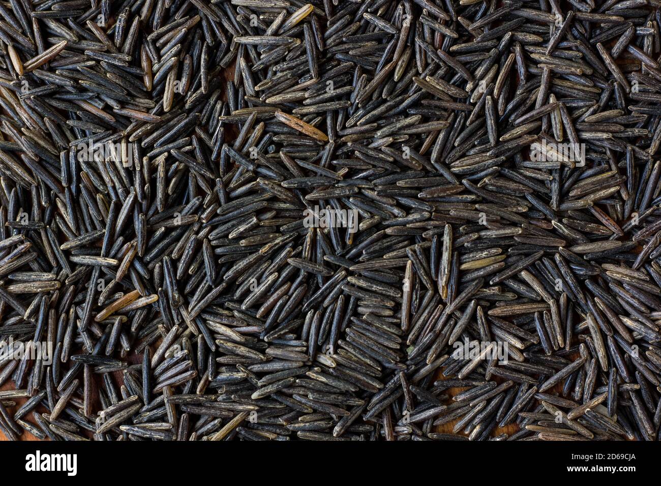 Wild rice background - black rice flat view Stock Photo - Alamy