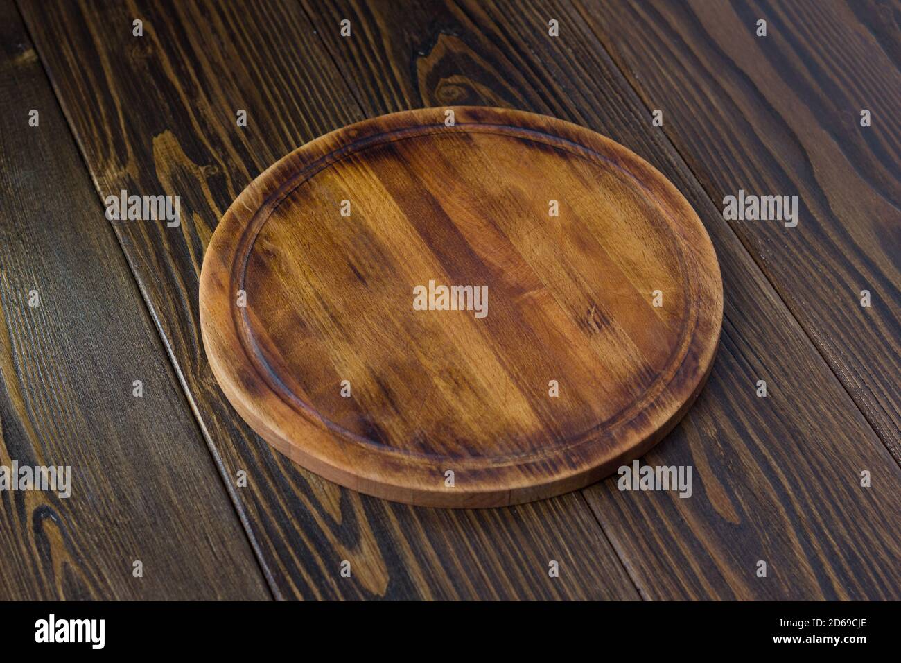 Kitchen board over wooden table as background Stock Photo - Alamy