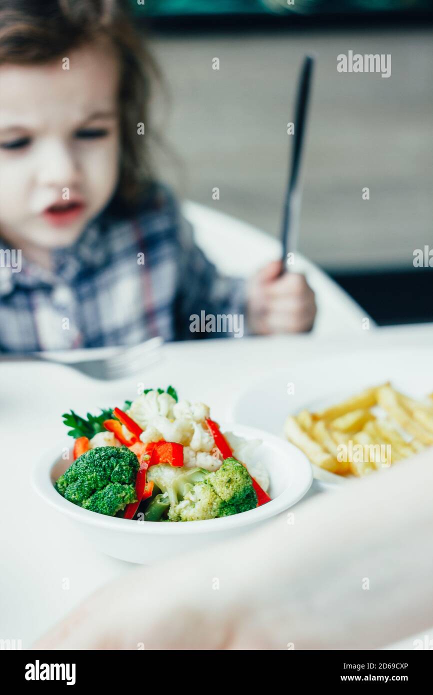 Kid in a restaurant and healthy food Stock Photo - Alamy