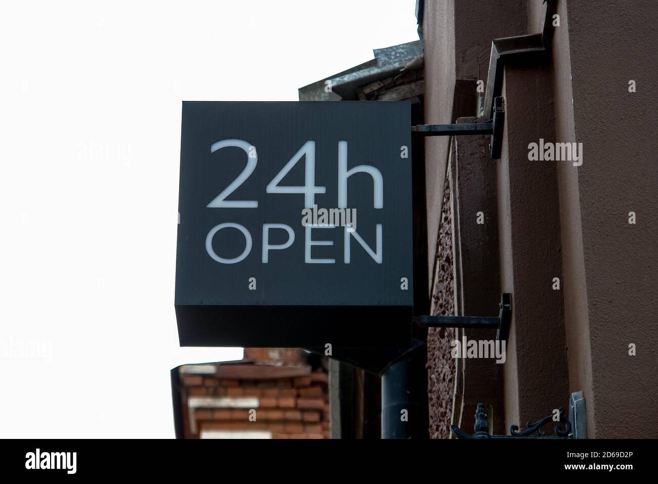 24 hours open signboard on a street on wall of store or resraurant ...