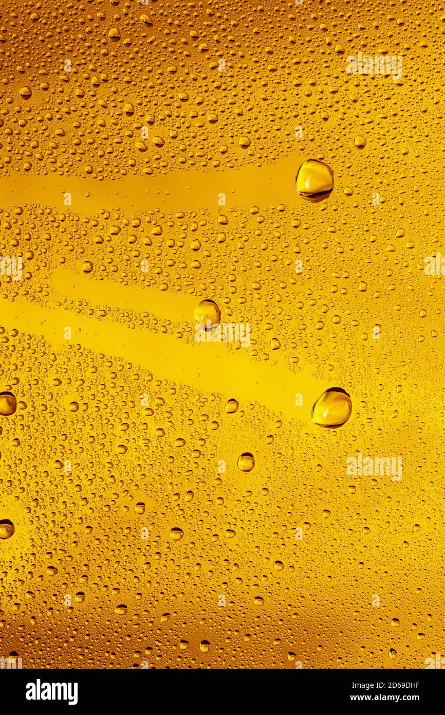 Close up view of cold drops on the glass of beer background. Texture of ...