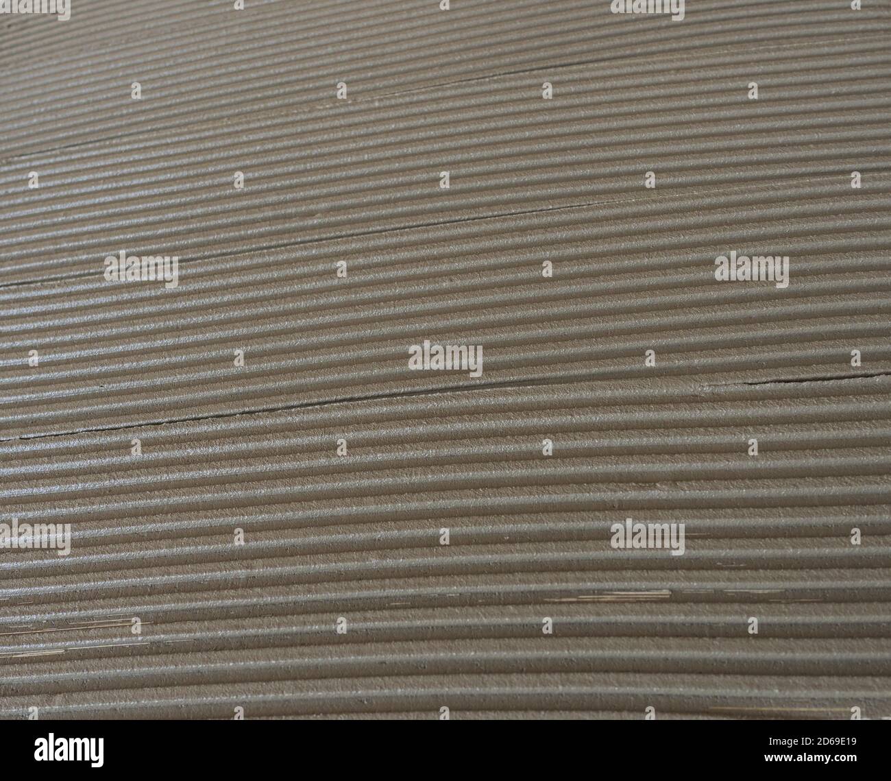 cementitious adhesive applied to the floor ready to receive the ceramic ...