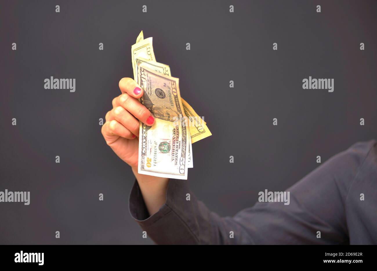 woman holding us dollar bank notes in her hand, black background Stock ...